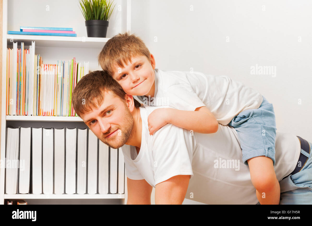 Close-up picture of boy riding on father's back Stock Photo - Alamy