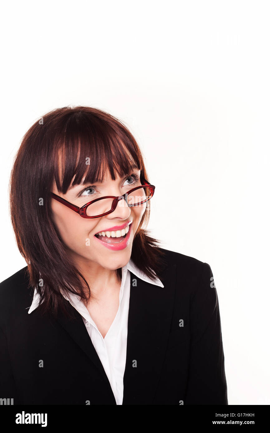 Laughing businesswoman looking up over the top of her glasses into the ...