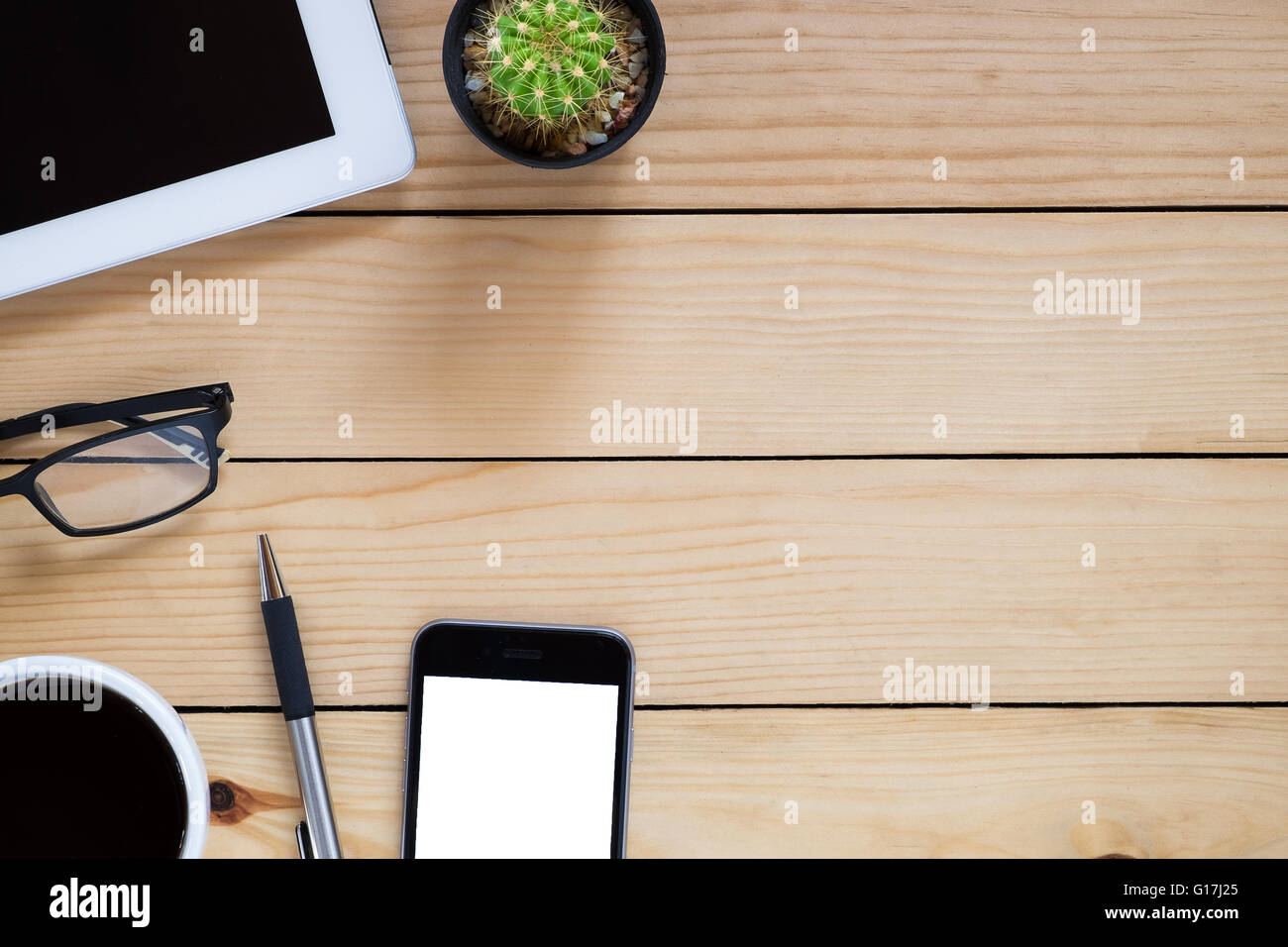 Office workplace with blank screen tablet, smartphone, pen and coffee ...