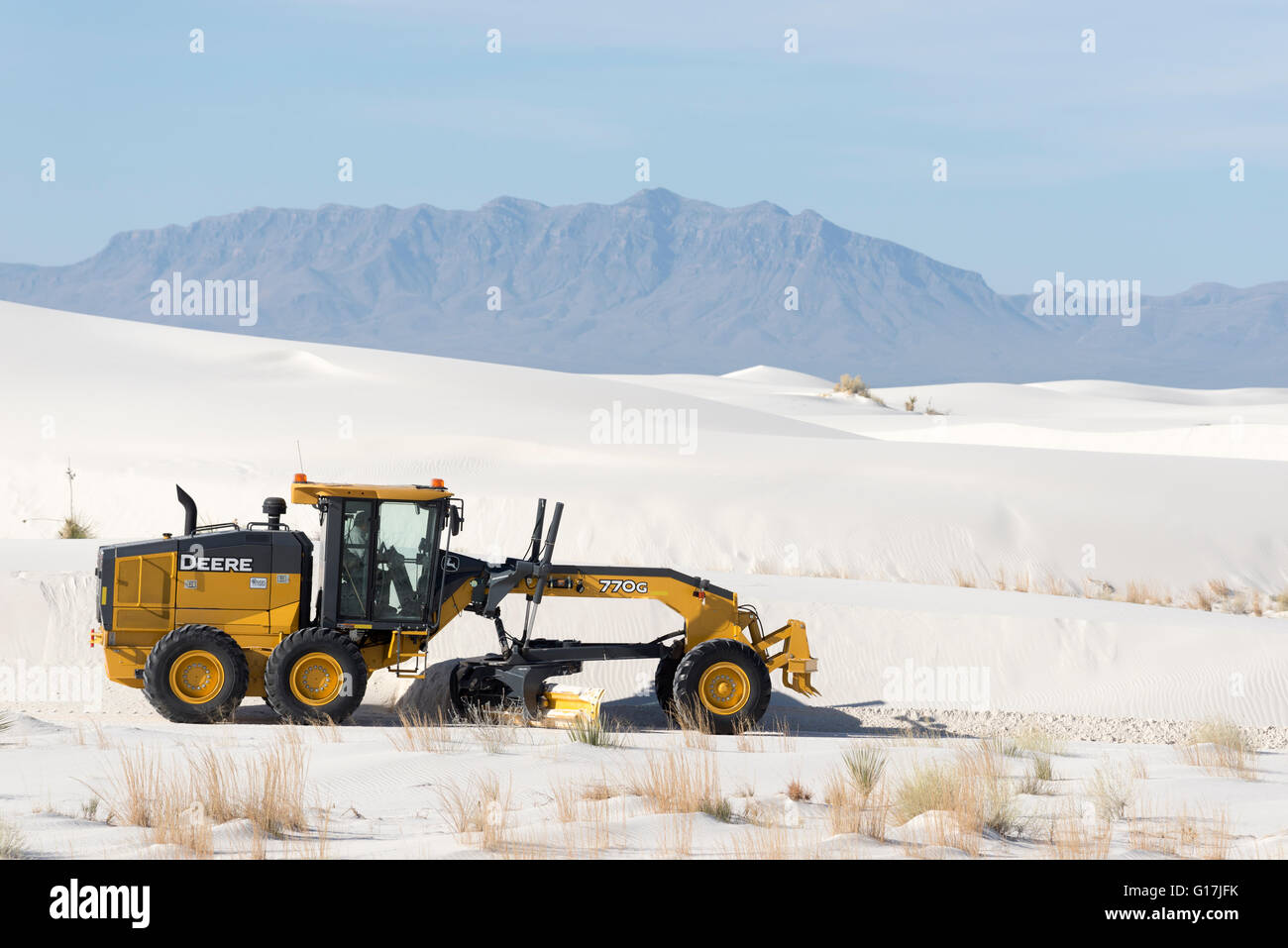 National Park Service road grader clearing sand from the road in White ...
