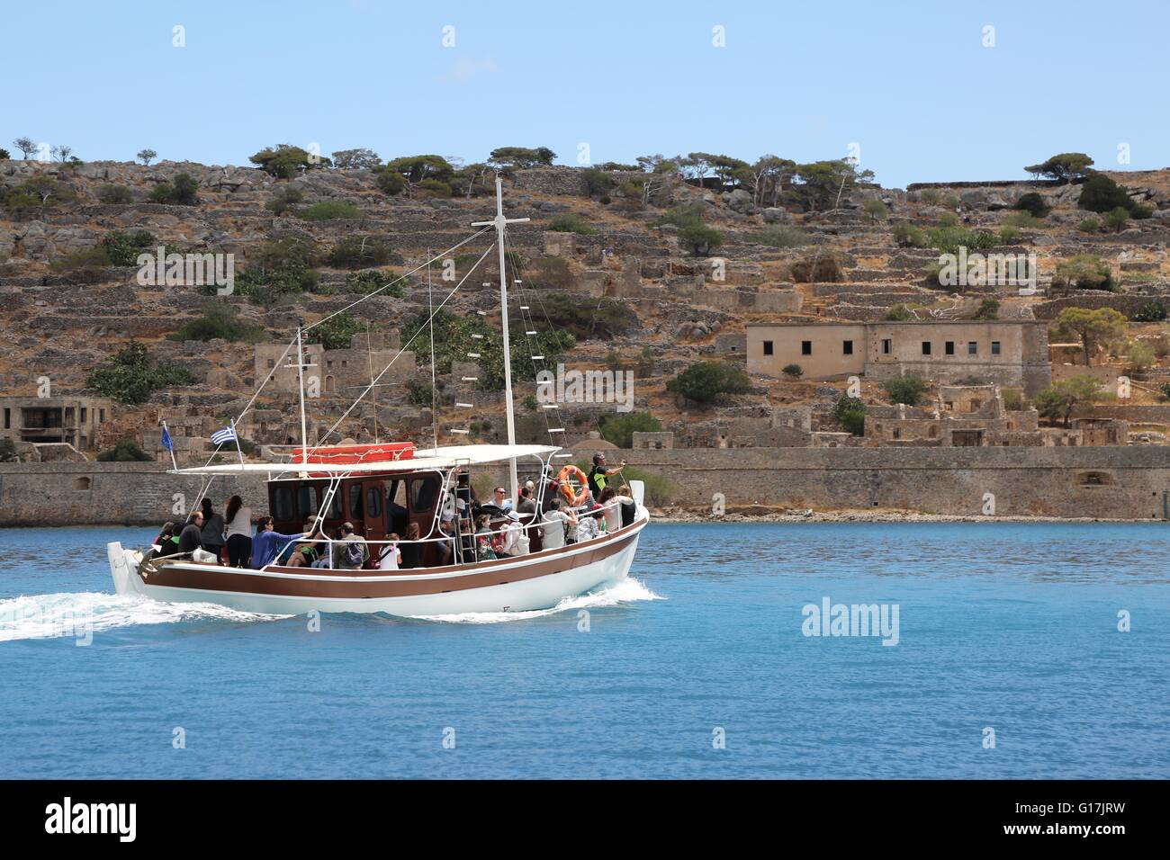 Tourist boats ferry tourists from Plaka Village to Spinalonga Island in ...