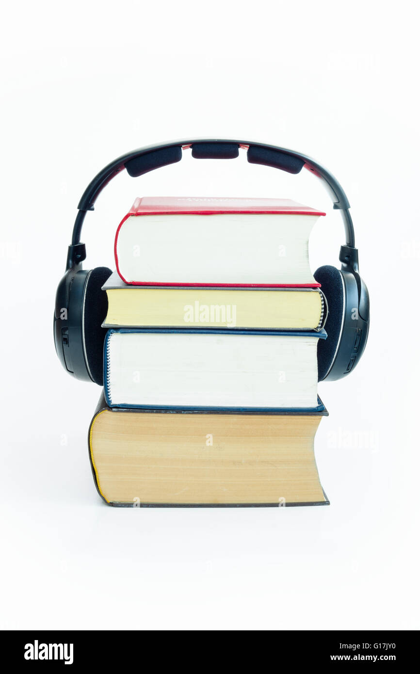 Headphones and group of books with isolated white background. The image ...