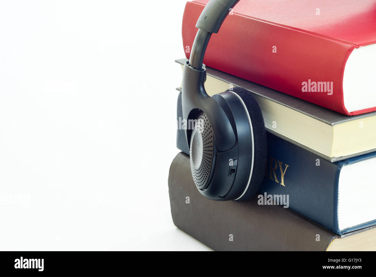 Headphones and group of books with isolated white background. The image ...
