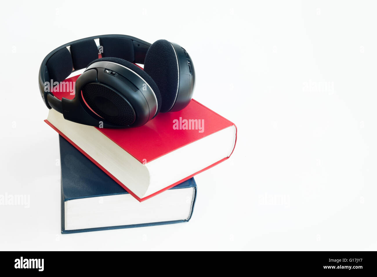 Headphones and group of books with isolated white background. The image ...