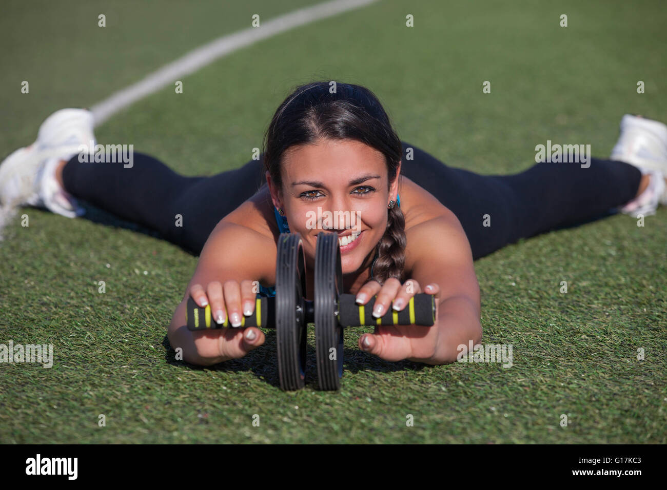 fitness female athlete exercising with toning wheel Stock Photo - Alamy