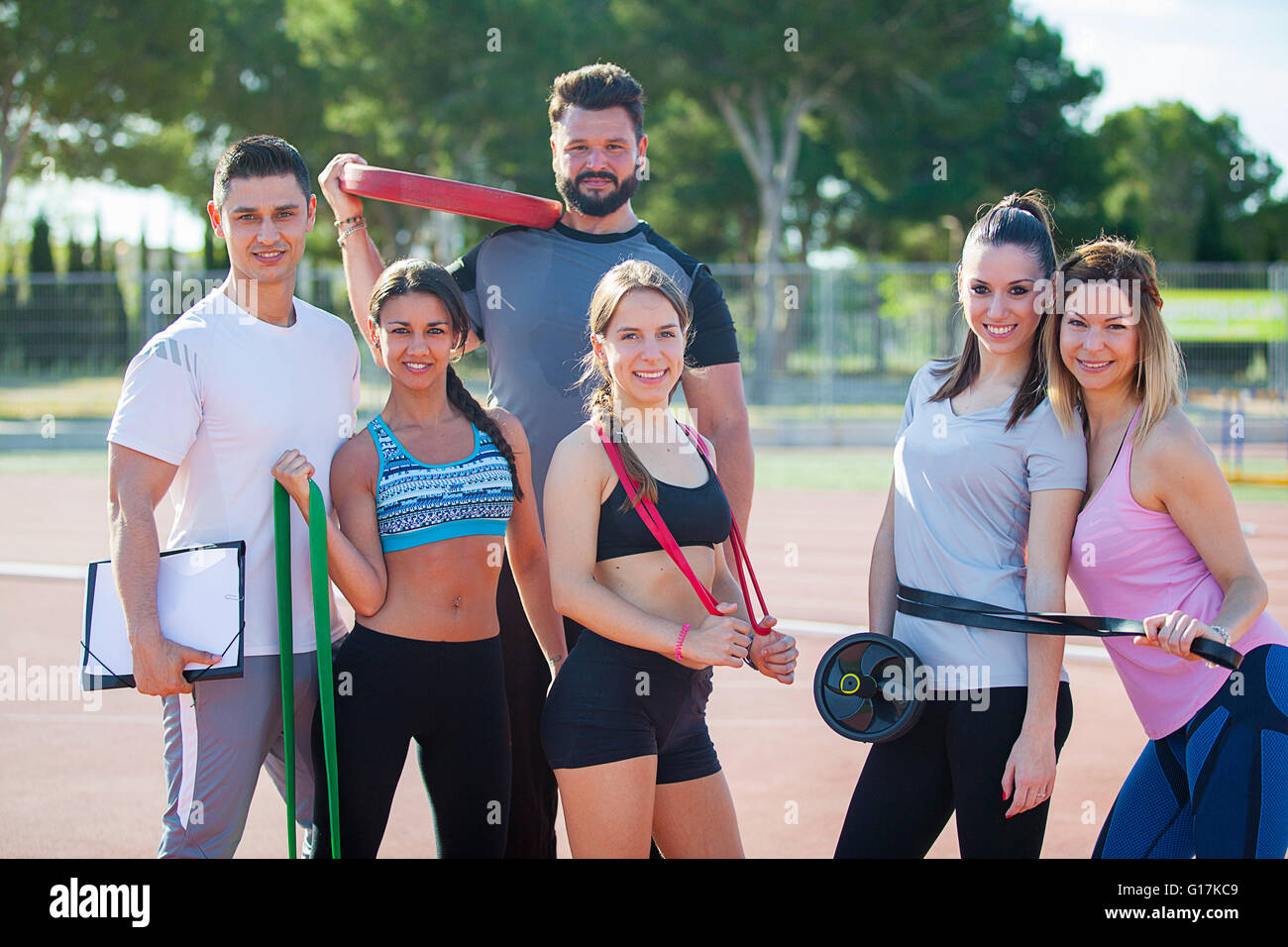 fitness class with gym equipment and trainer Stock Photo - Alamy