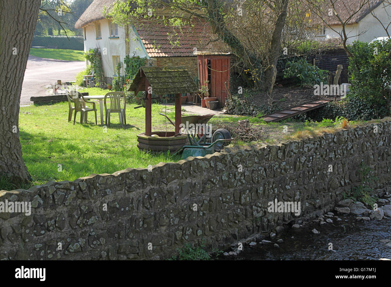 A quiet Rural scene in a Devon Village with wishing well, thatched ...