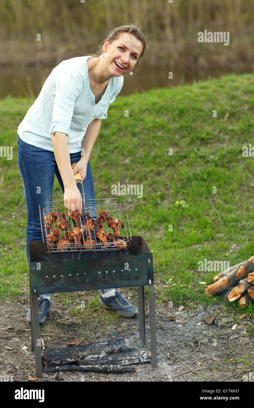 Young pretty girl preparing food on grill Stock Photo - Alamy