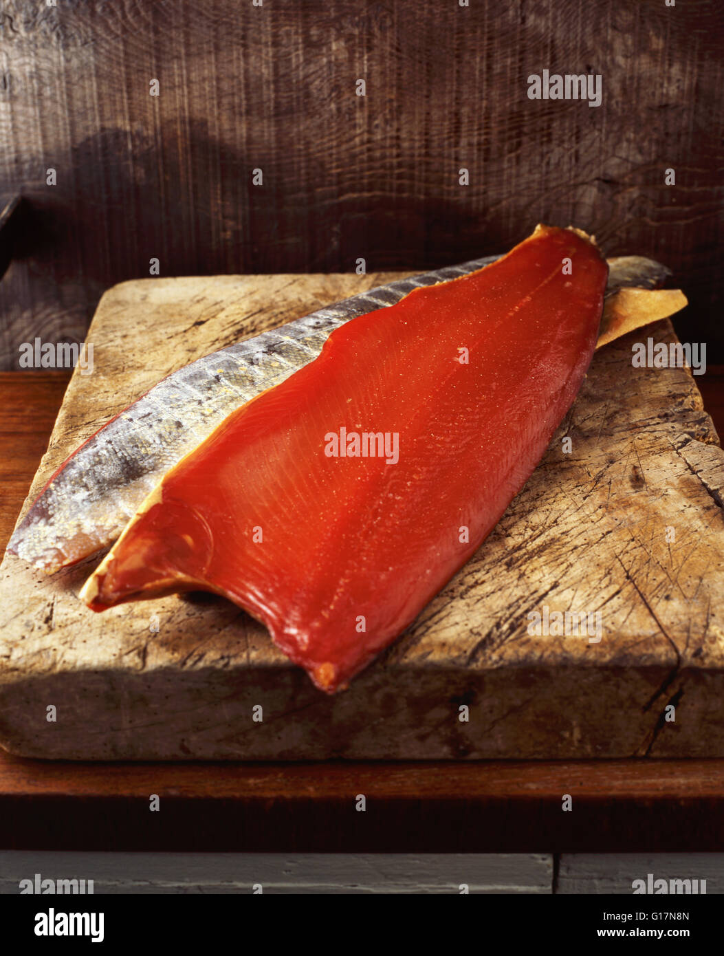 Smoked side of salmon on wooden chopping board Stock Photo - Alamy