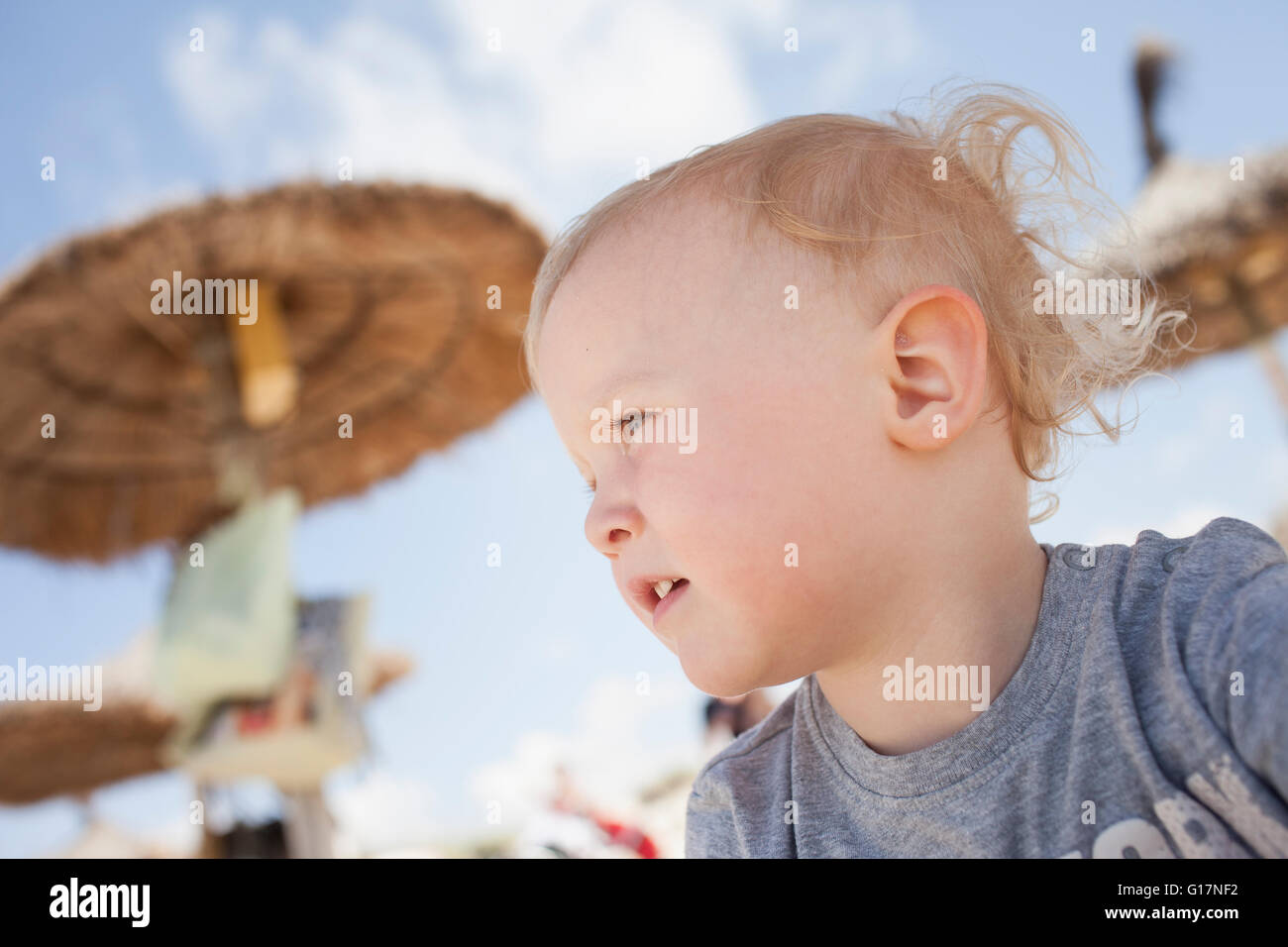 Baby girl, sitting outdoors, low angle view Stock Photo - Alamy