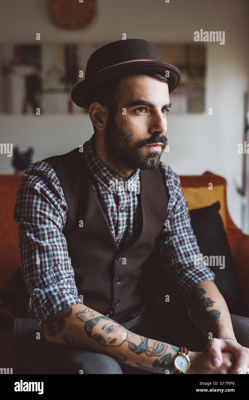 Young man daydreaming indoors Stock Photo - Alamy