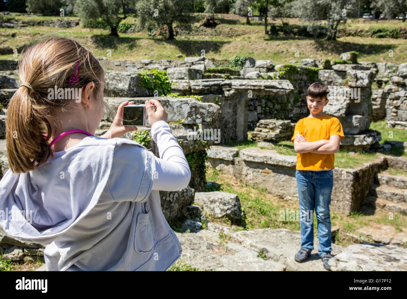 Girl photographing her brother at ruins, Florence, Italy Stock Photo ...