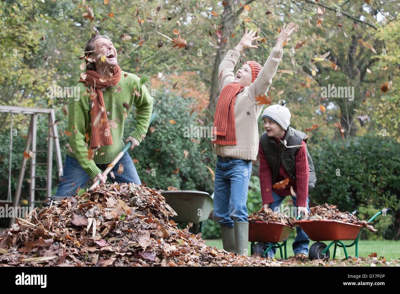 Boy throwing autumn leaves into the air hi-res stock photography and ...