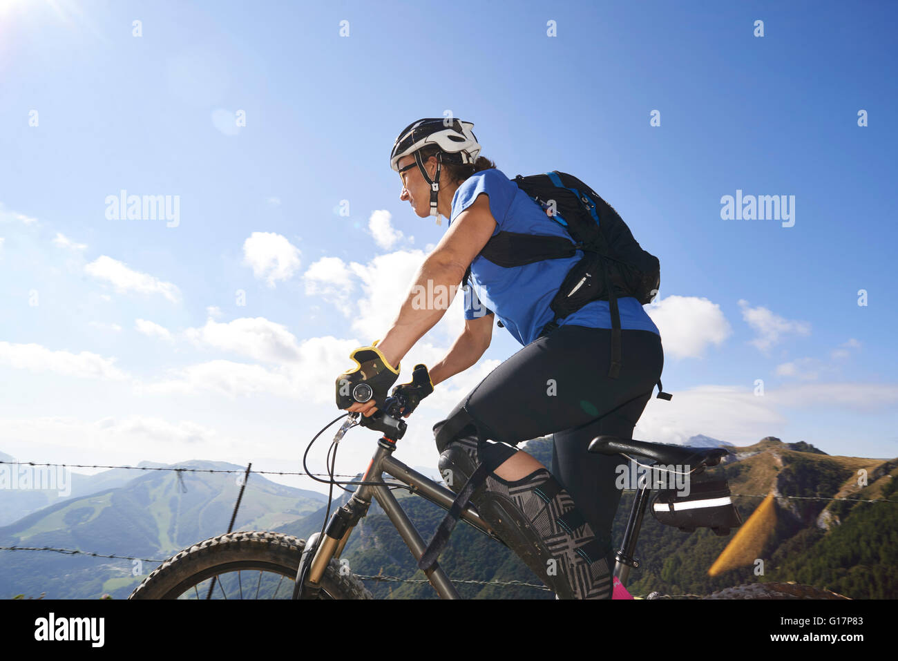 Low angle side view of cyclist on bicycle in mountains Stock Photo - Alamy