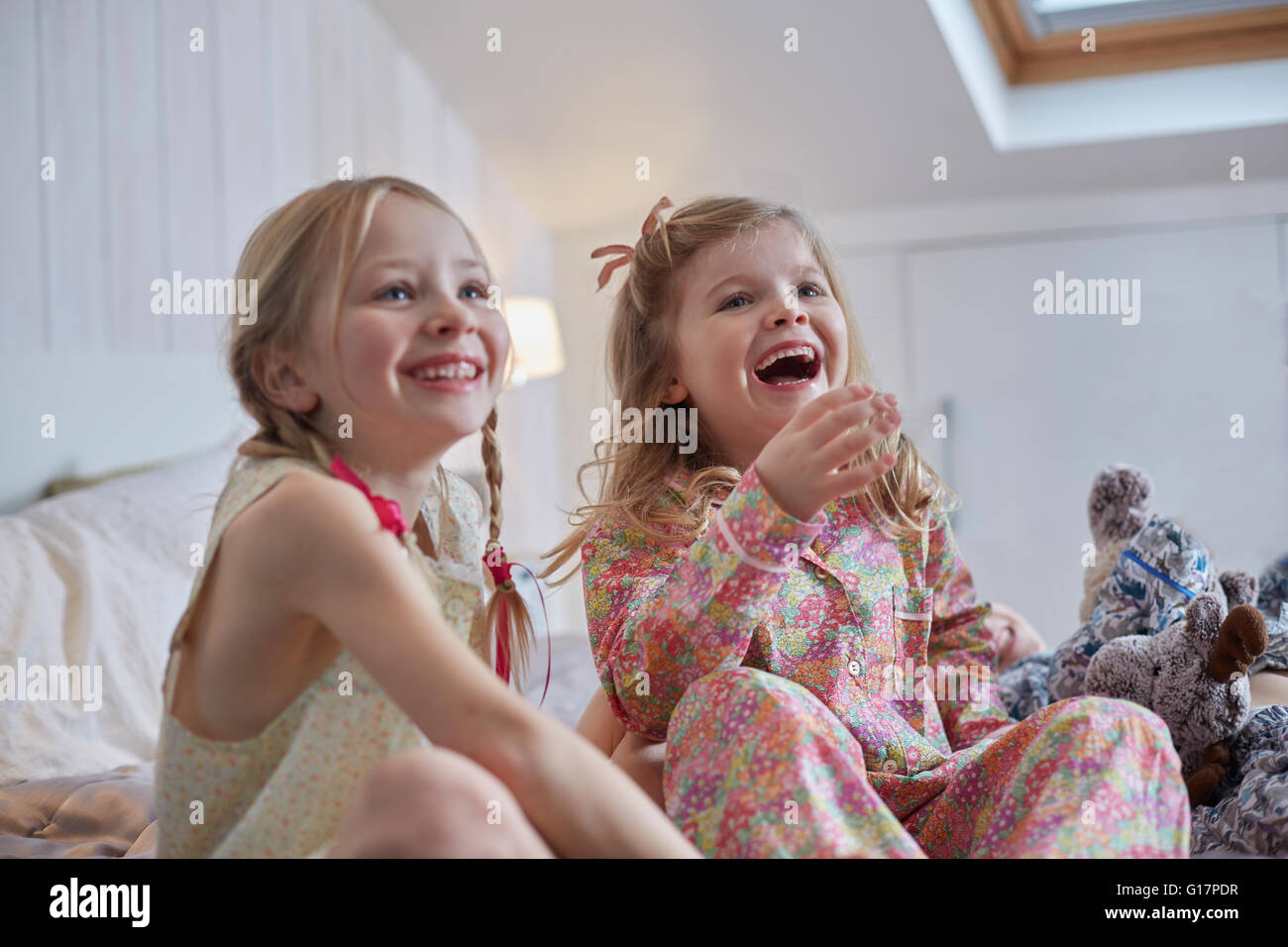 Girls laughing in loft room Stock Photo - Alamy