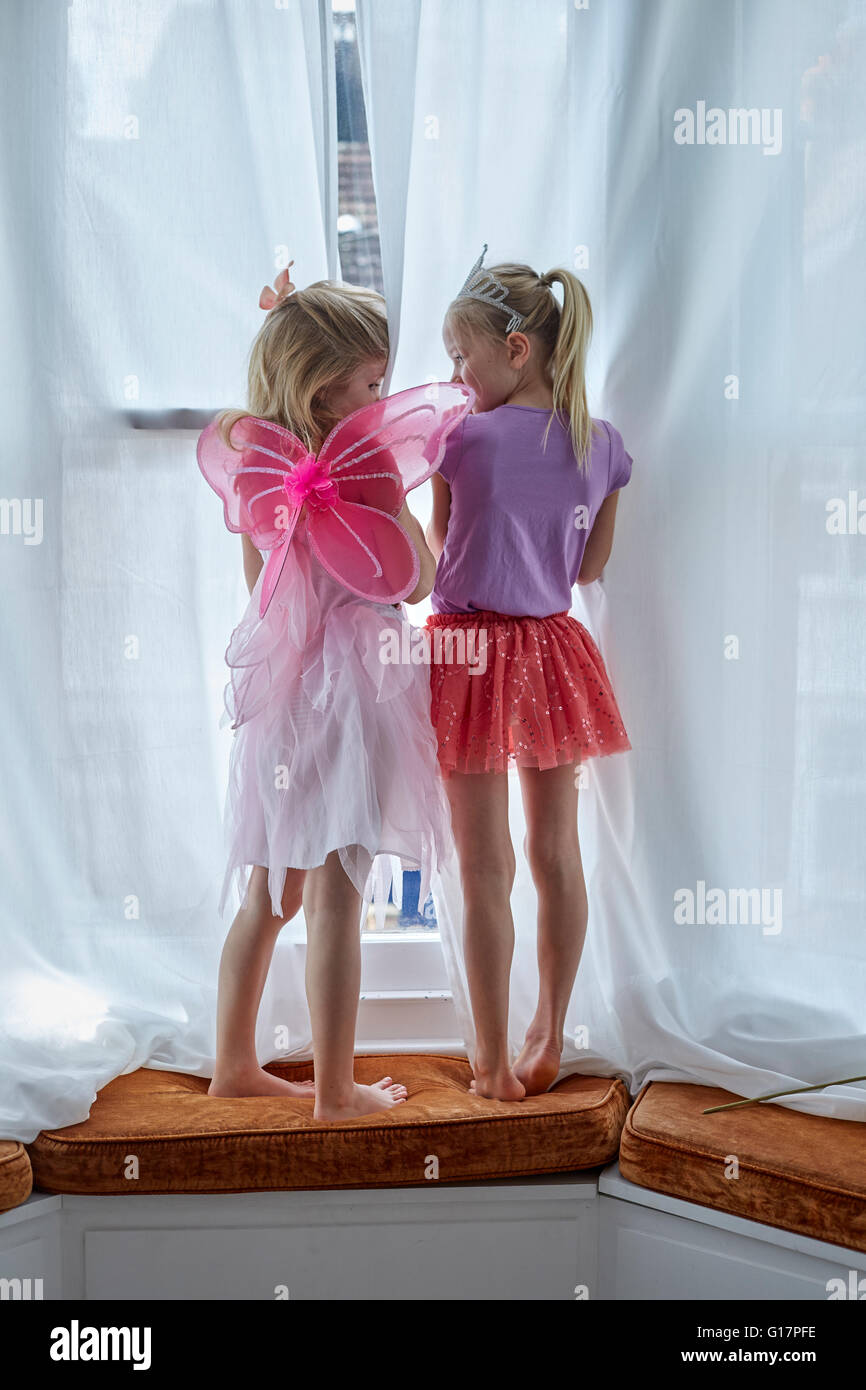 Girls in costume at bay window Stock Photo - Alamy