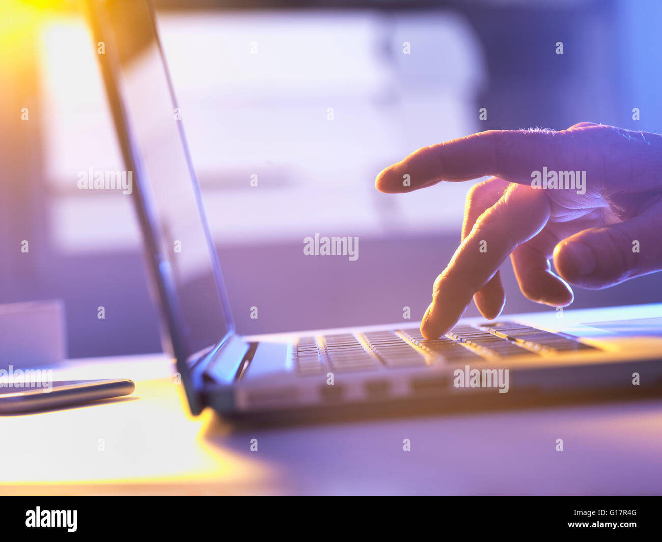 Man working online at a laptop computer Stock Photo - Alamy