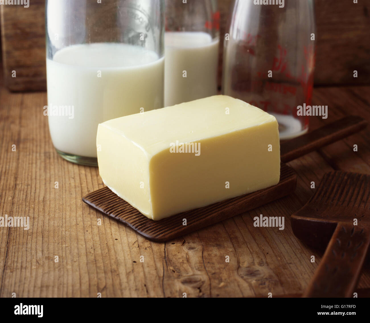 Butter block with milk bottles on wooden table Stock Photo - Alamy