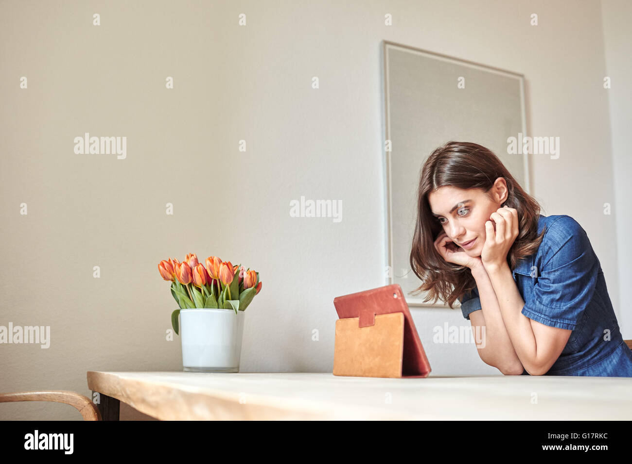 Young woman sitting dining table hi-res stock photography and images ...