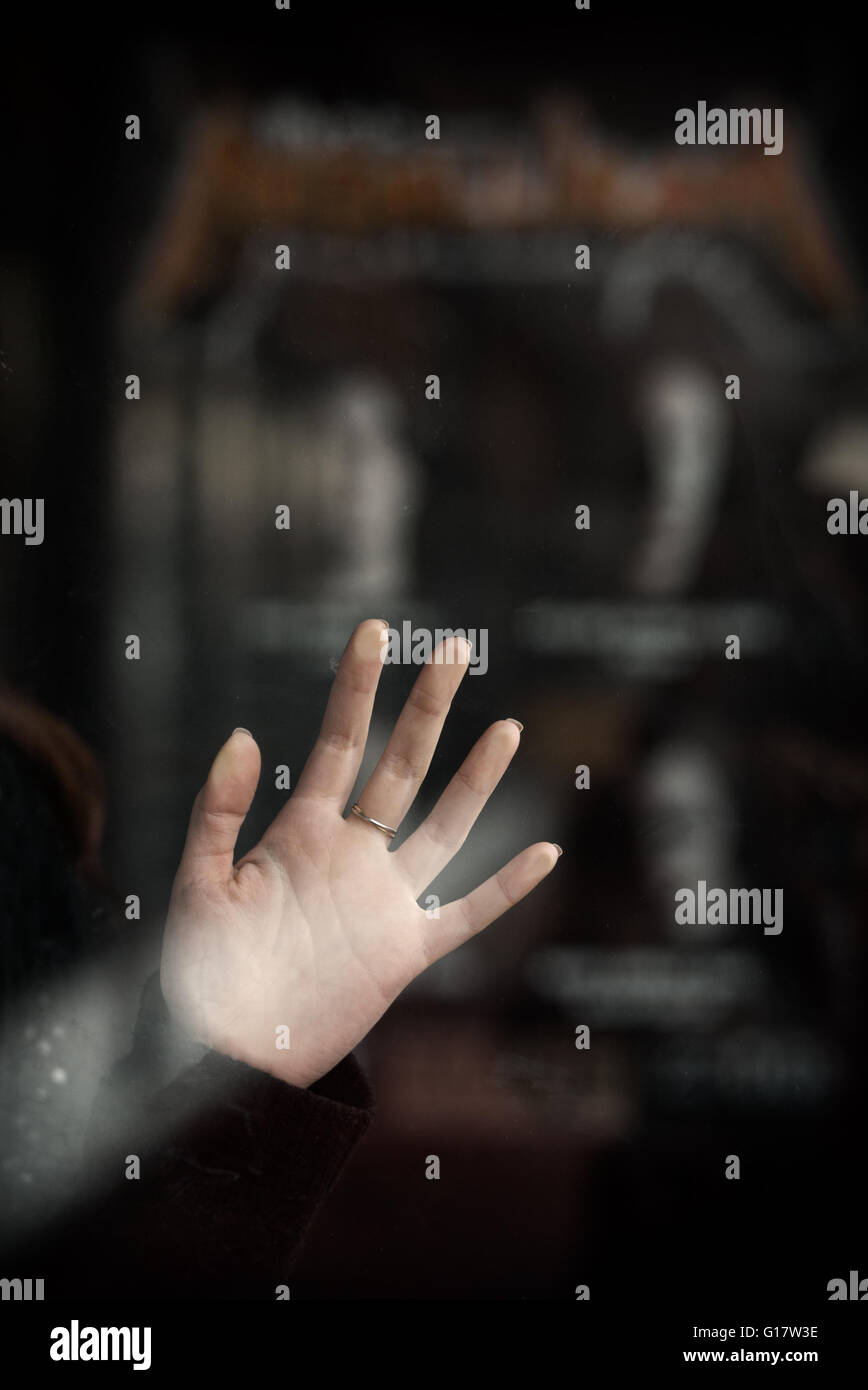 Hand behind the window Stock Photo - Alamy