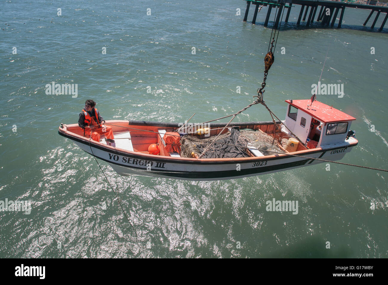 Launching fishing boat with crane Stock Photo - Alamy