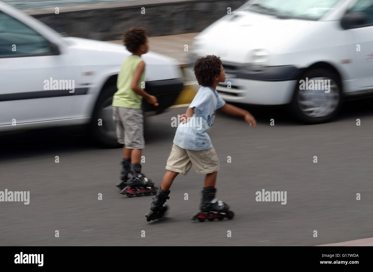 Two metis children playing roller skates Stock Photo - Alamy