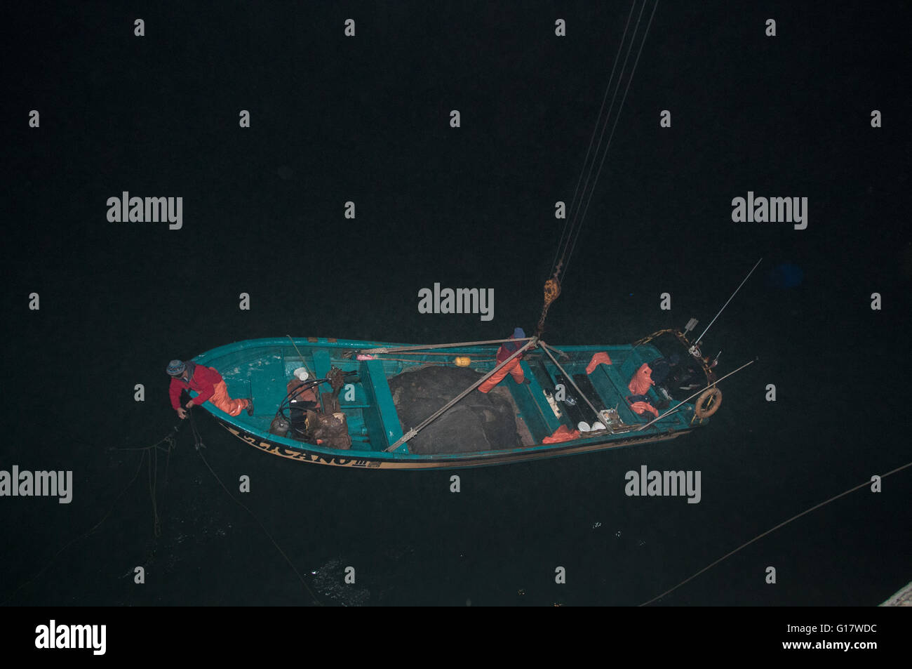 Launching fishing boat with crane Stock Photo - Alamy