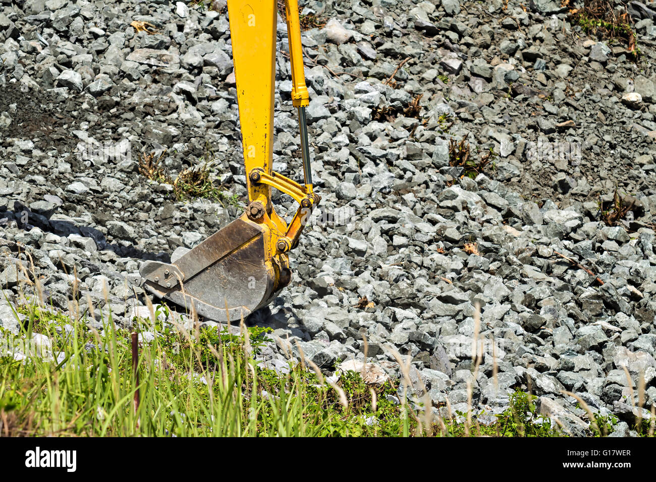 excavator shovel digging rock on constriction site Stock Photo - Alamy