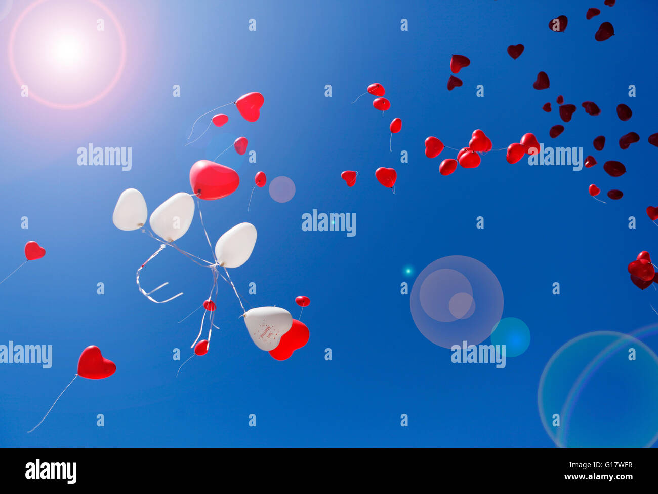 many heart shape balloons flying in the blue sky Stock Photo - Alamy