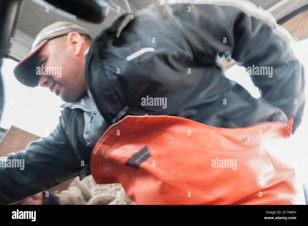 Captain driving boat Stock Photo - Alamy