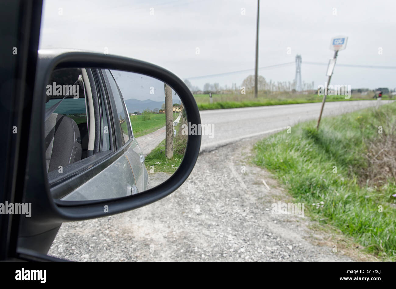 Country road seen from the rearview mirror Stock Photo - Alamy