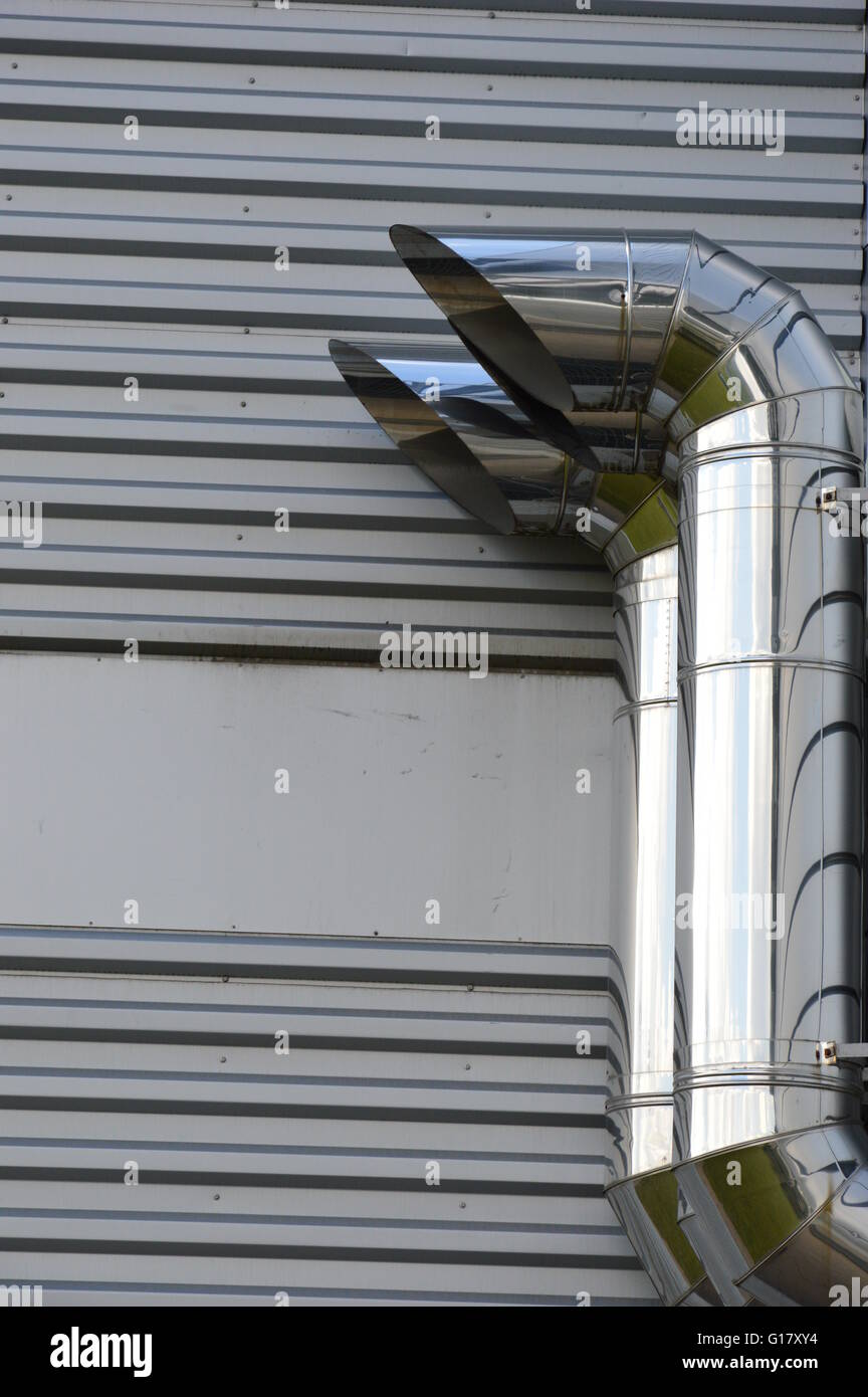 Three metal pipes on building Stock Photo - Alamy