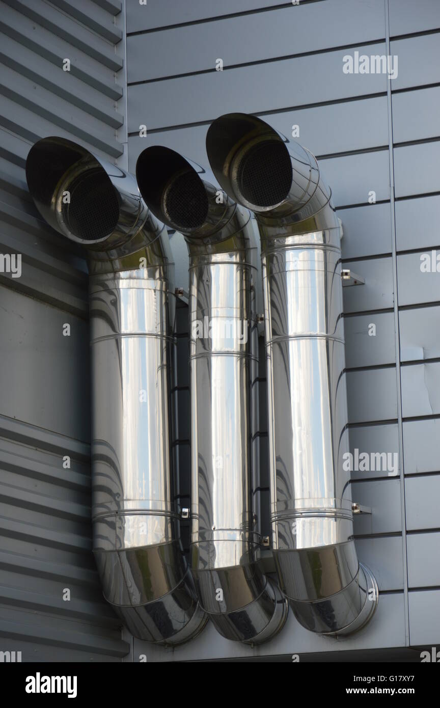 Three metal pipes on building Stock Photo - Alamy