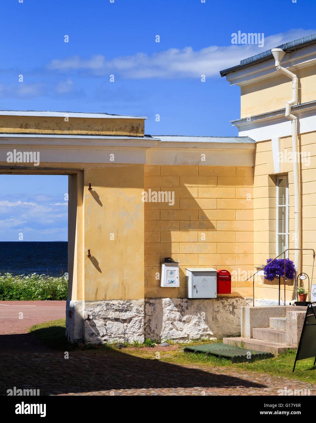 Interior of café courtyard with blue sky and ocean in landscape ...