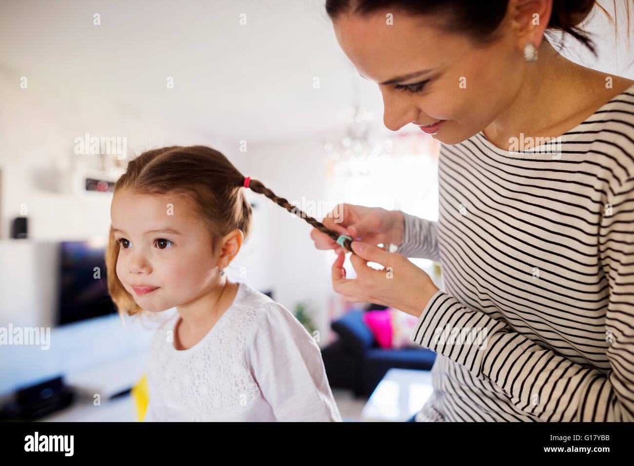 Mother braiding child hair hi-res stock photography and images - Alamy