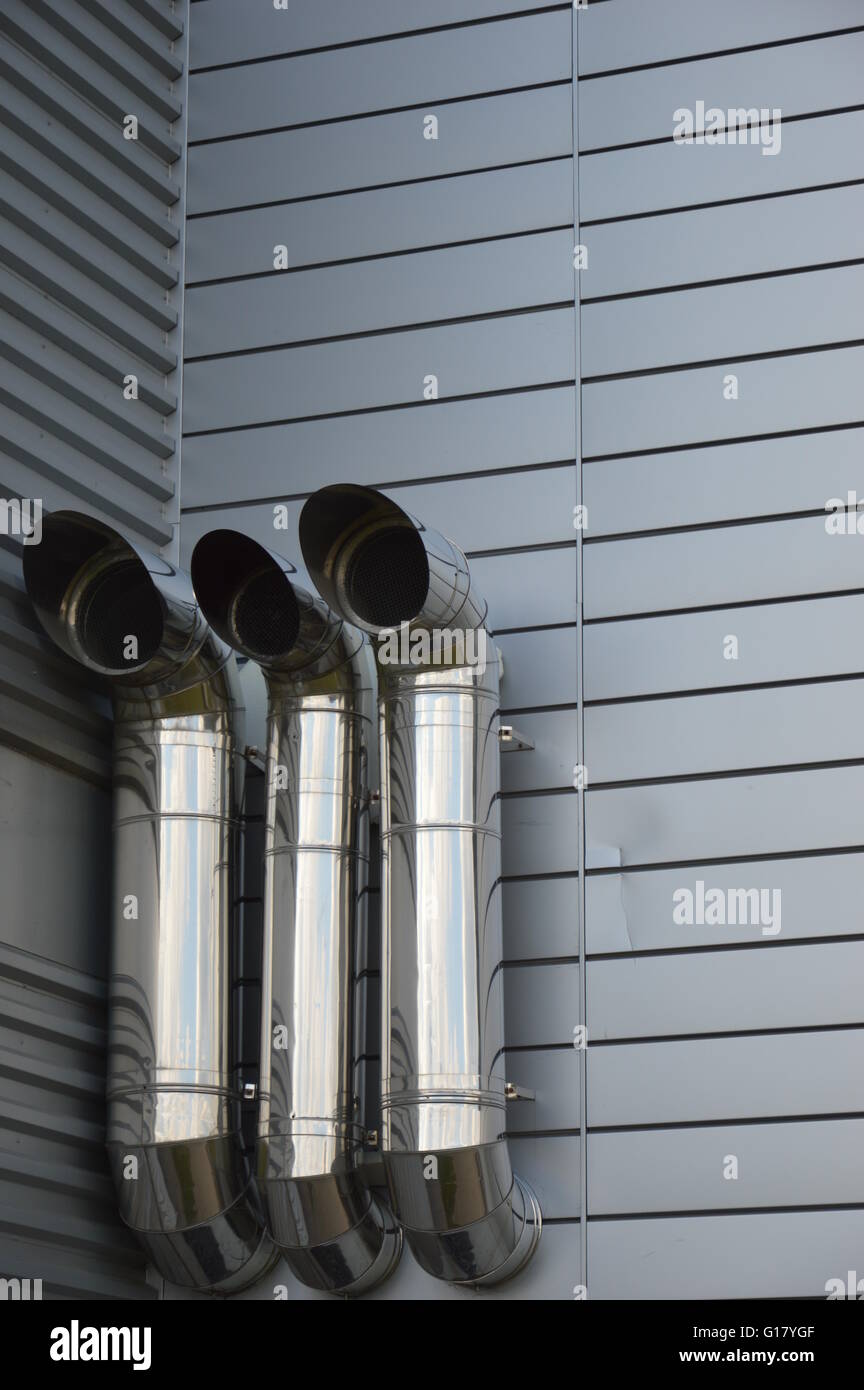 Three metal pipes on building Stock Photo - Alamy
