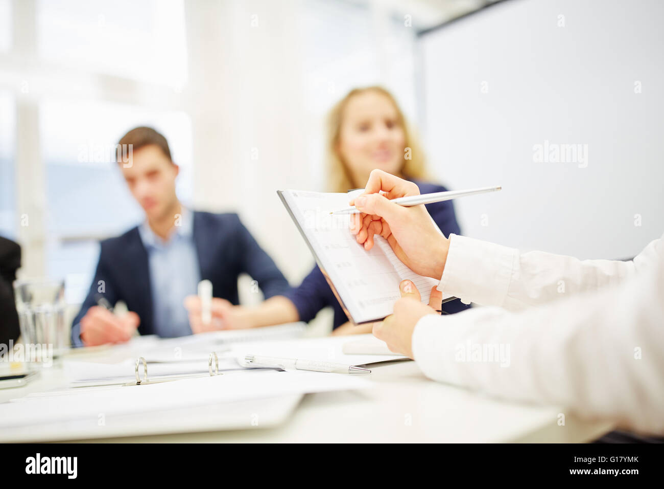 Hand taking notes in a consulting business meeting Stock Photo - Alamy