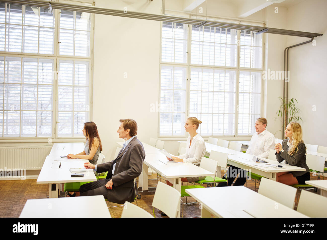Business people sitting as an audience during a business seminar for ...