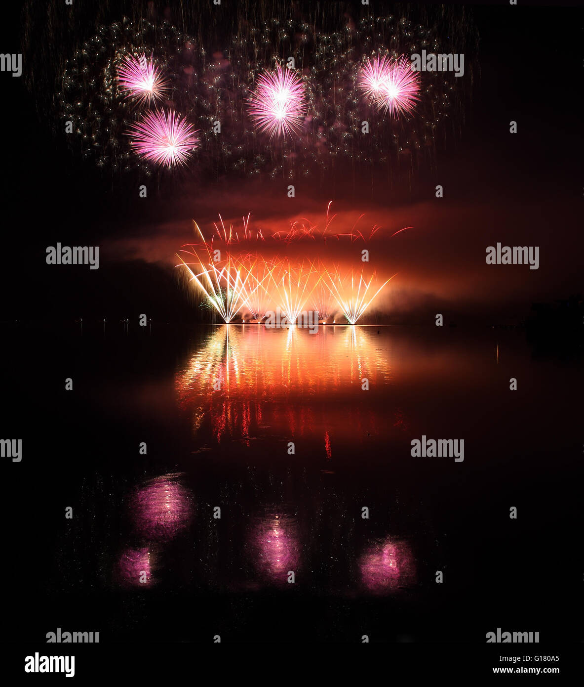 Colorful fireworks with reflection on lake and night sky in background ...