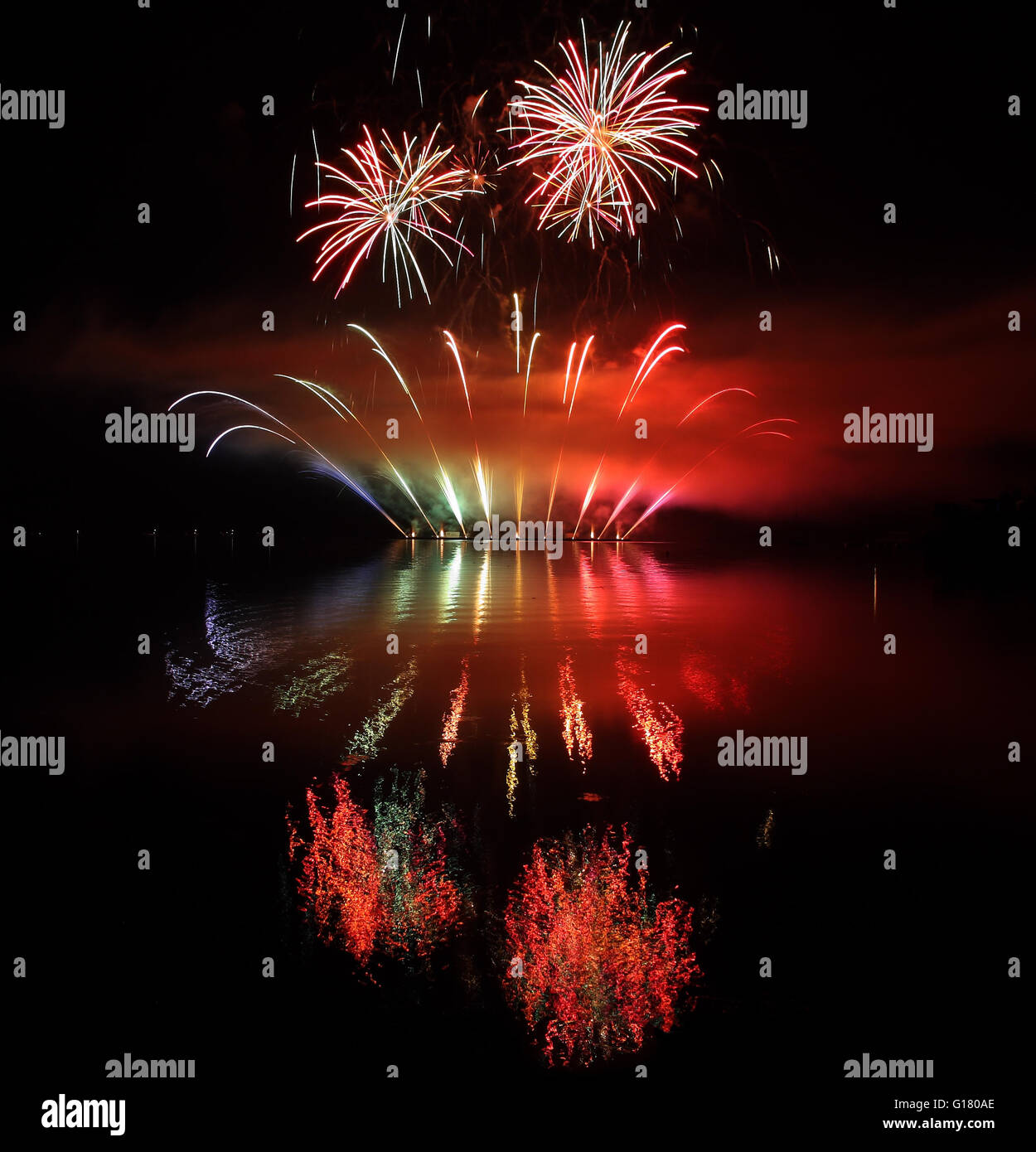 Colorful fireworks with reflection on lake and night sky in background ...
