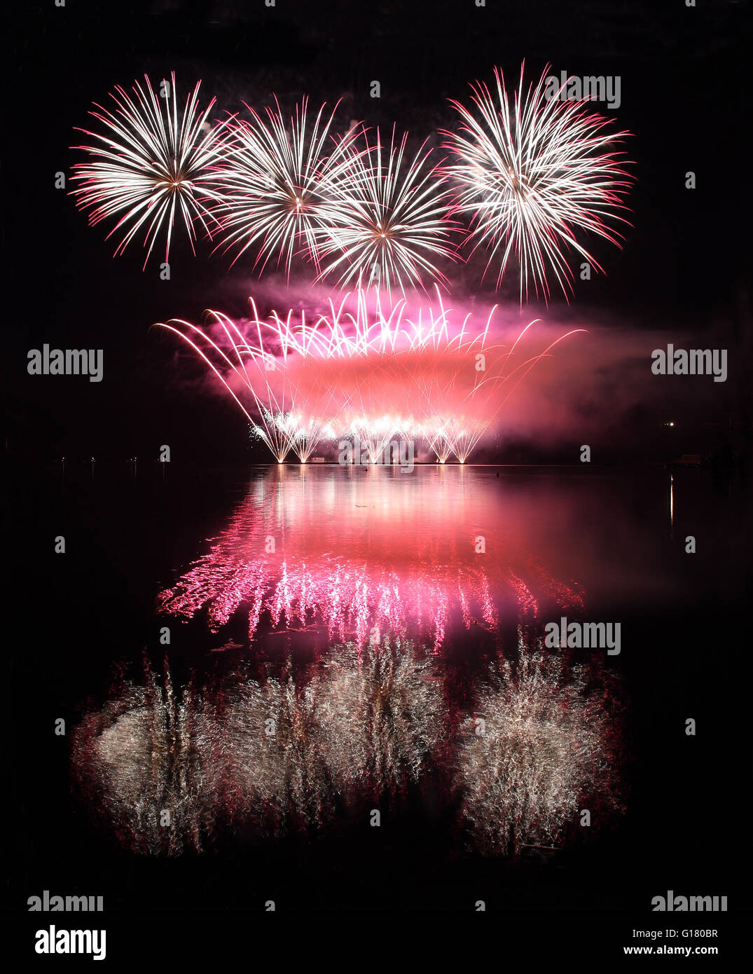Colorful fireworks with reflection on lake and night sky in background ...