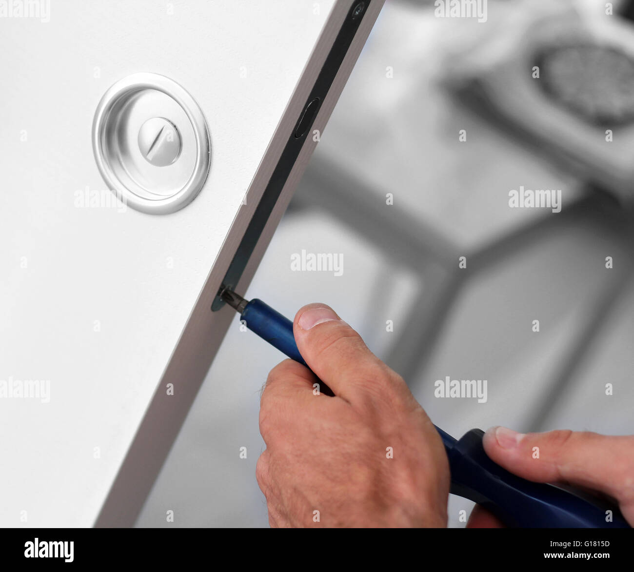 Repairman fixing a door lock, construction and architecture concepts ...