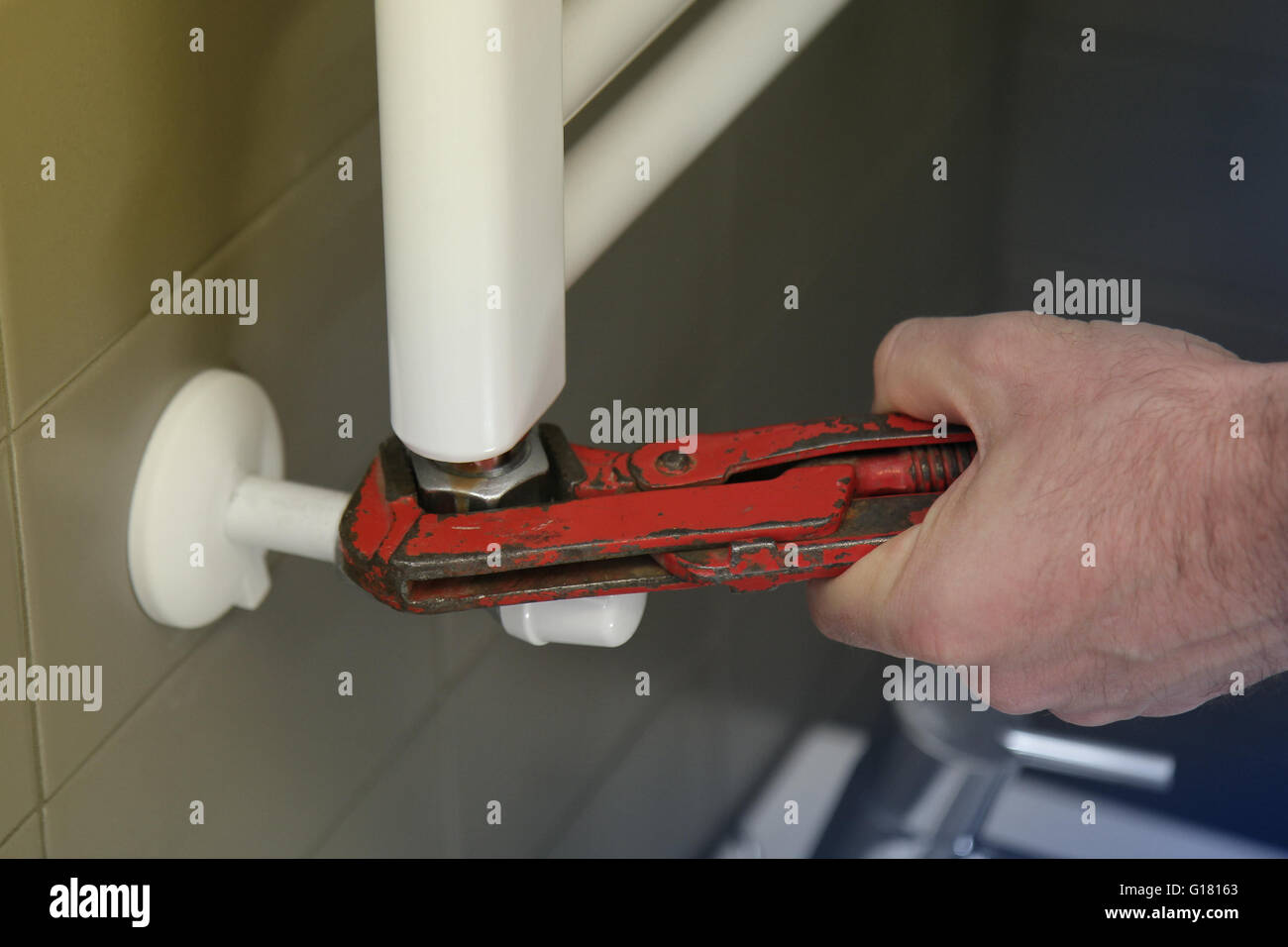 Plumber fixing a radiator, construction and architecture concepts Stock ...