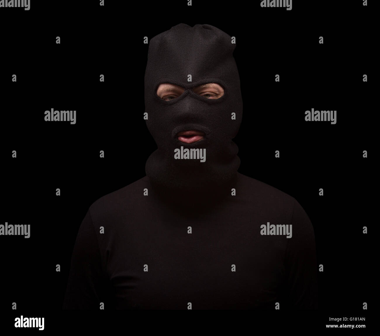 Masked thief on black Stock Photo - Alamy