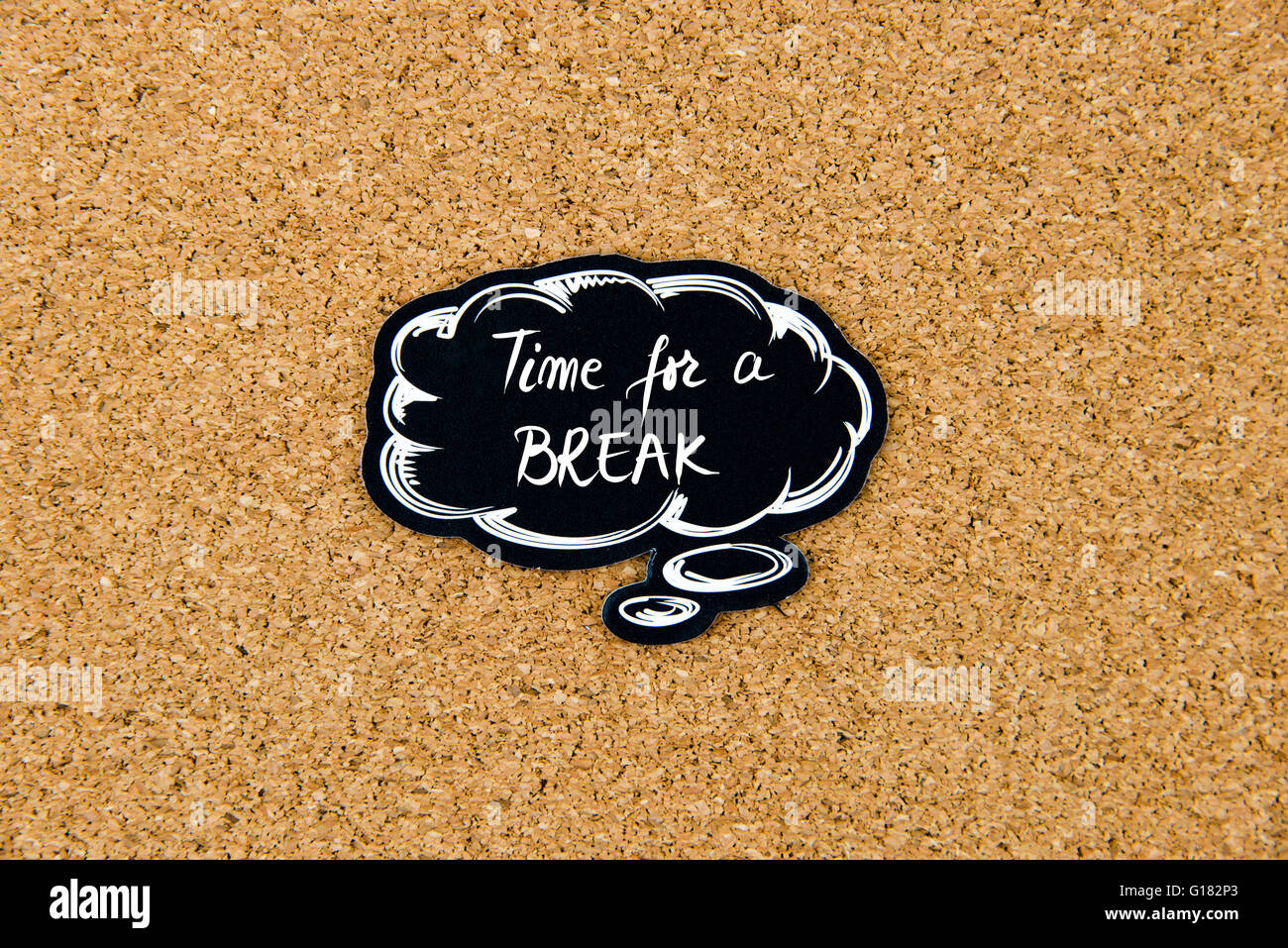 Time For A Break written on black thinking bubble over cork board ...