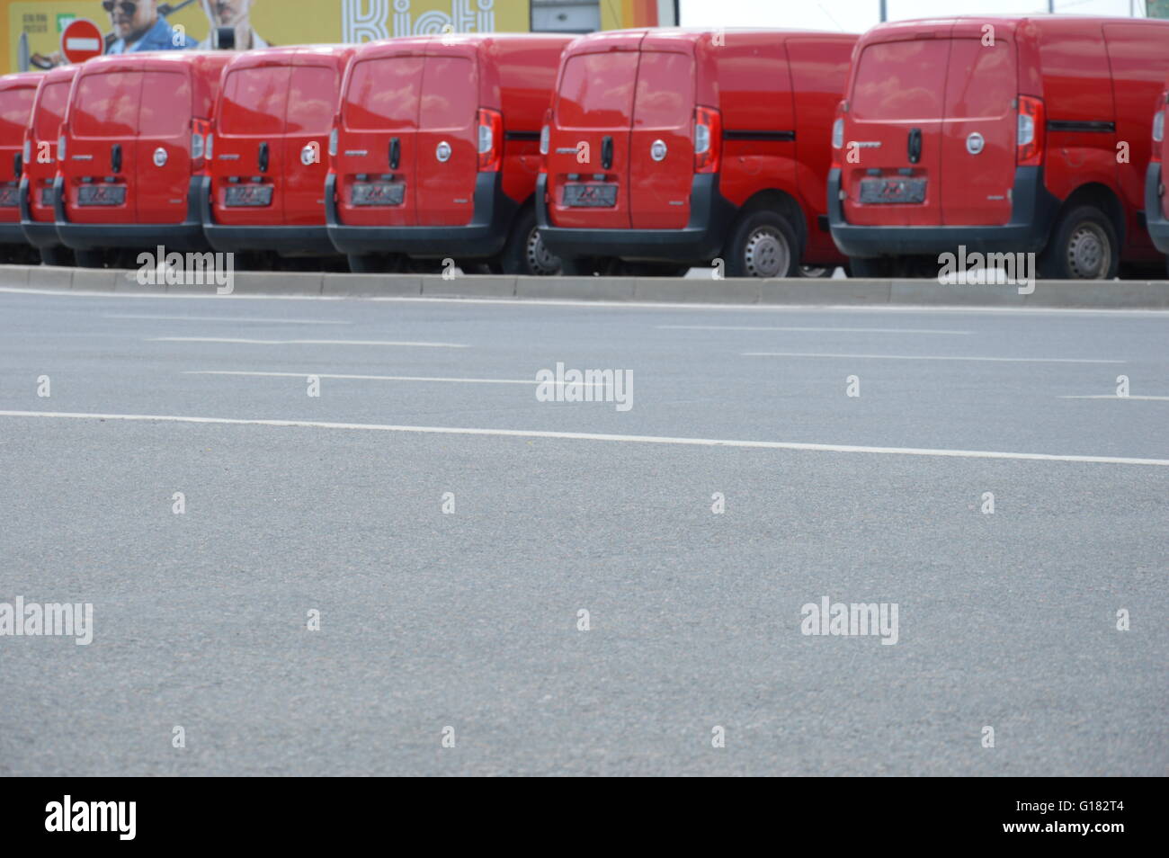 Row of red unused cars Stock Photo - Alamy
