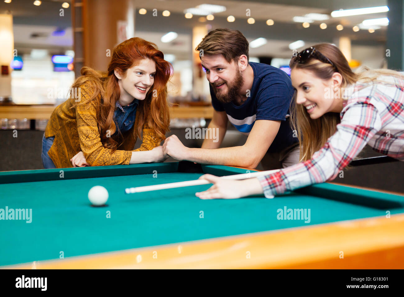 Friends enjoying playing billiards Stock Photo - Alamy
