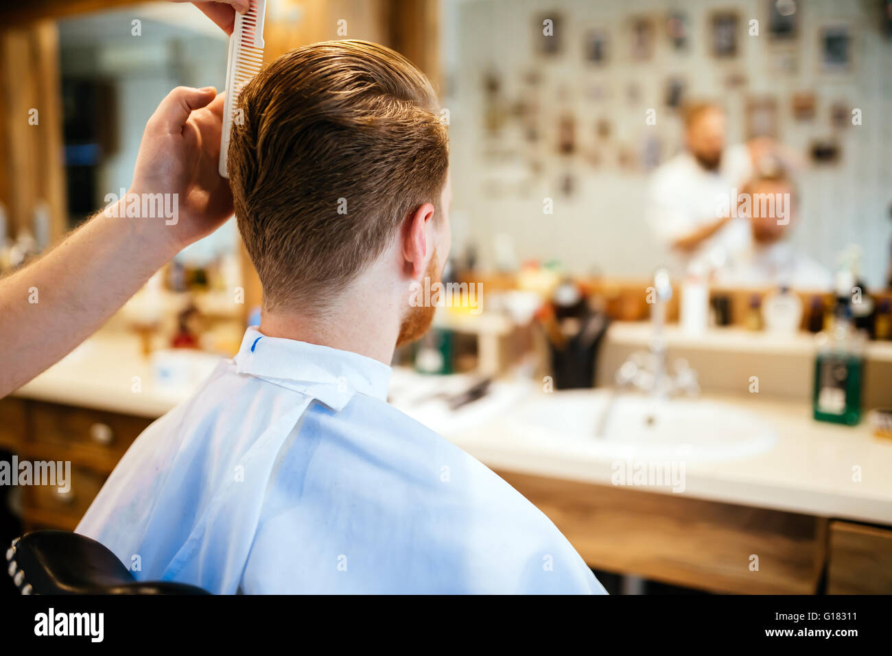Combing of hair and styling in barber shop Stock Photo - Alamy