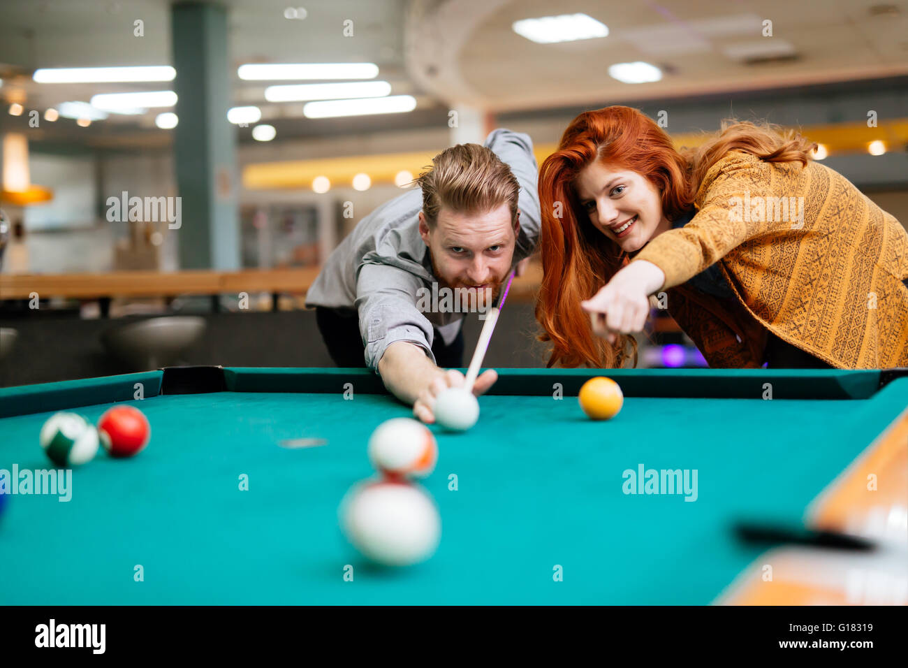 Couple playing billiards and bonding Stock Photo - Alamy