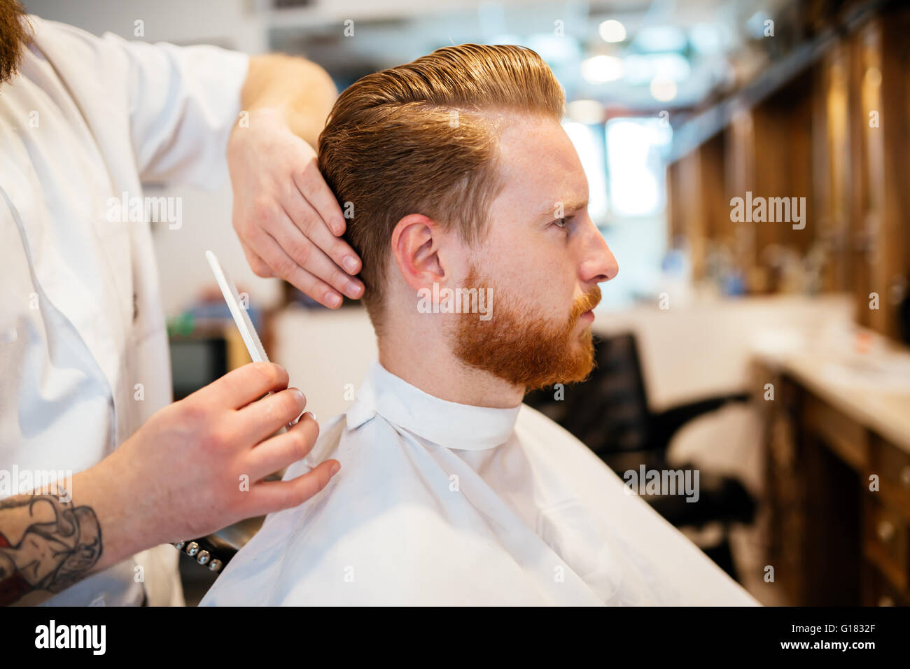 Combing of hair and styling in barber shop Stock Photo - Alamy